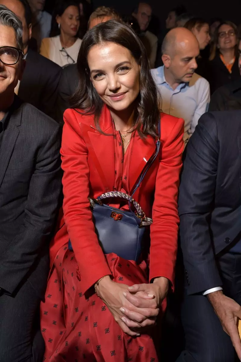 Katie Holmes iført en rød kjole under et modeshow