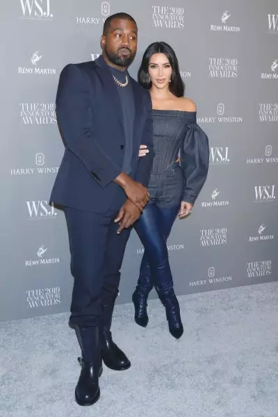 Kim Kardashian heldur í handlegg eiginmanns Kanye West