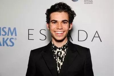 Cameron Boyce mete yon jakèt kostim nwa kap souri