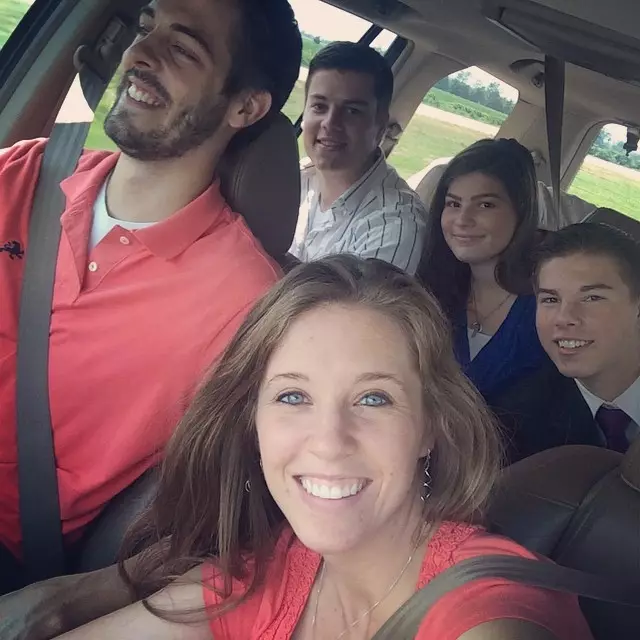 Jill Duggar eta Derick Dillard aurreko eserlekuan Selfiea hartzen Bates haurrekin atzeko eserlekuan